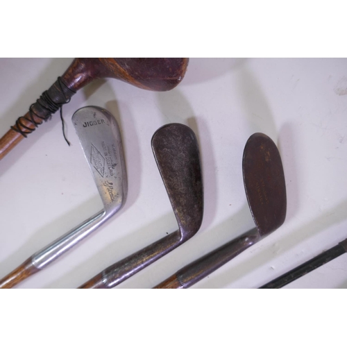 Collection of antique and vintage golf clubs, the majority stamped ...