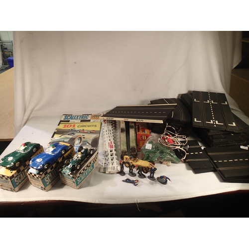 Two Scalextric E2 Aston Martin with lights cars, one blue, one green ...