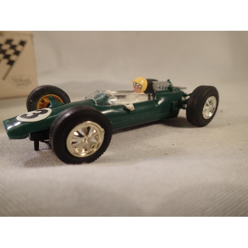 Two Scalextric E2 Aston Martin with lights cars, one blue, one green ...