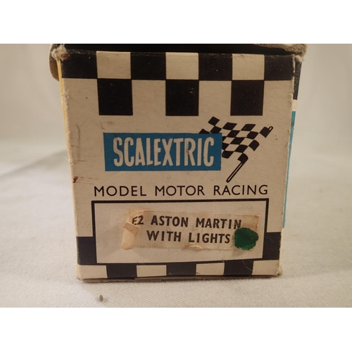 Two Scalextric E2 Aston Martin with lights cars, one blue, one green ...