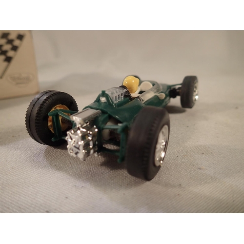 Two Scalextric E2 Aston Martin with lights cars, one blue, one green ...