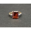 GARNET AND DIAMOND RING the rectangular cut central garnet measuring ...
