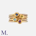 Four Gem-set Stacking Rings in 18k yellow gold, each band bell set with ...