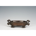 A bronze oval incense burner, Qing Dynastyof oval section supported on ...