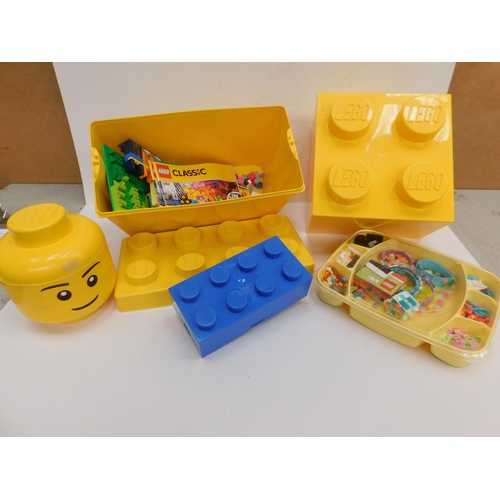 Five Lego storage containers - some with pieces/ instructions