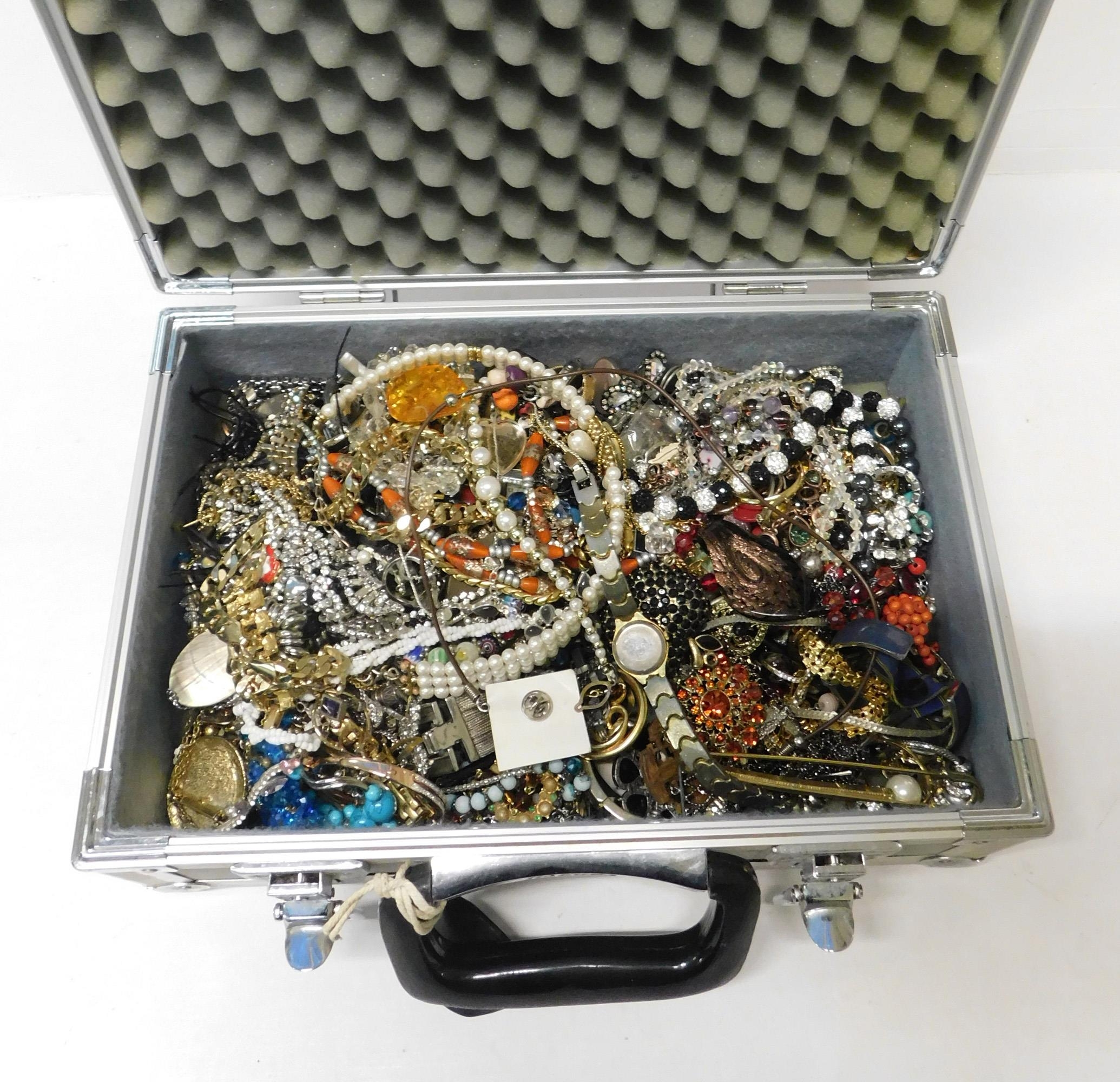 Aluminium case filled with costume jewellery