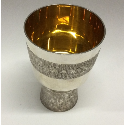 A modernistic silver drinking beaker of bark design. London 1971 ...
