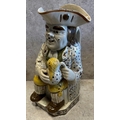 An early pottery Toby jug of typical form decorated in bright colours ...