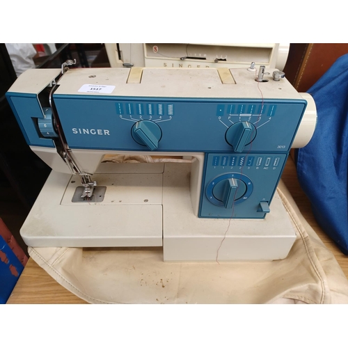 A Singer 3013 electric sewing machine with cover