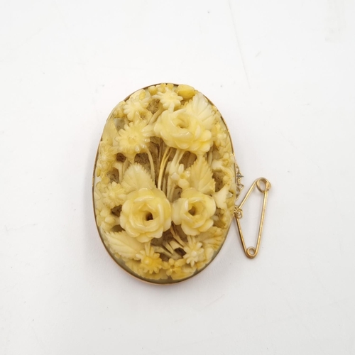 A 19th century 9ct gold mounted carved ivory pin brooch with floral ...