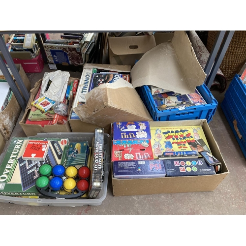 Five boxes containing assorted boxed board games and jigsaw puzzles to ...