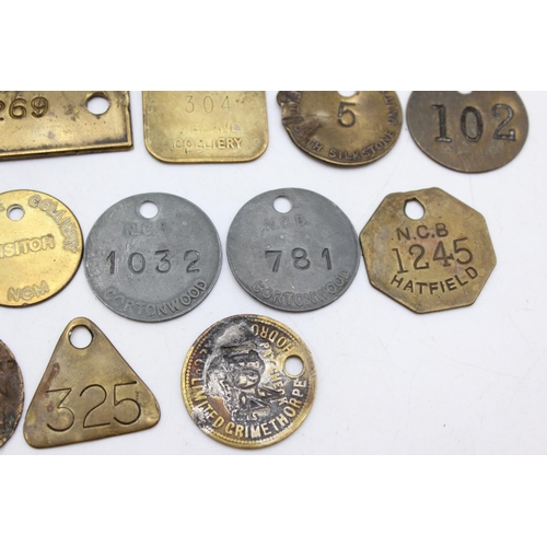 Twelve vintage brass miners and colliery pit check tags