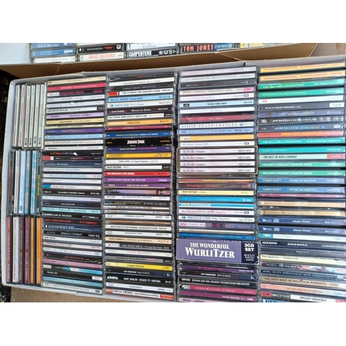Four boxes, two containing CDs and two containing compact cassettes ...