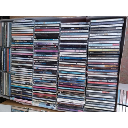 Four boxes, two containing CDs and two containing compact cassettes ...