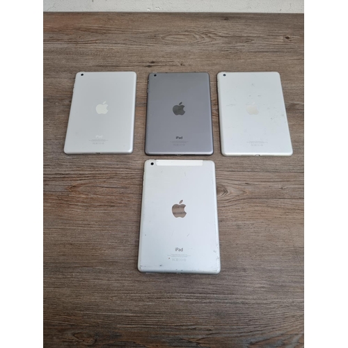 Four Apple iPad Mini tablets, three A1432 and one A1455
