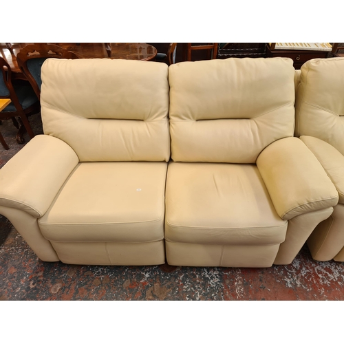 A modern cream leather three piece lounge suite comprising two ...