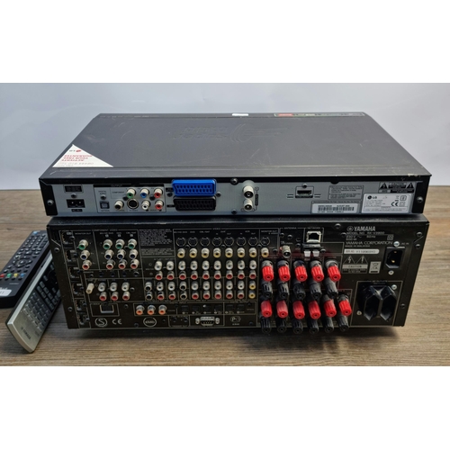 Two items with remote controls, one Yamaha RX-V3900 AV receiver and one ...