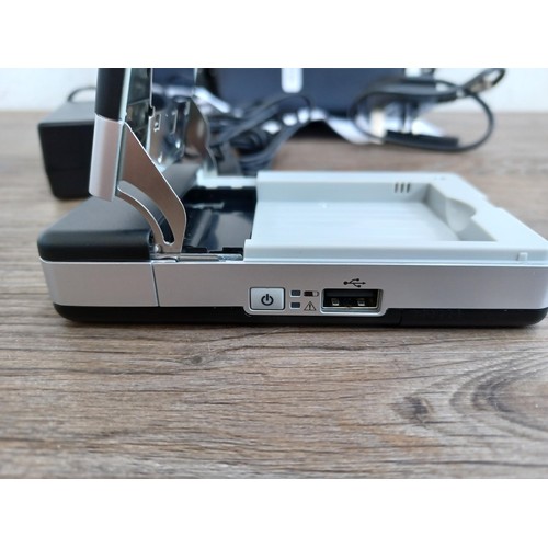 A cased Polaroid CZA-10011B PoGo instant mobile photo printer with ...