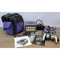 A Nintendo Gamecube console with three controllers and carry case