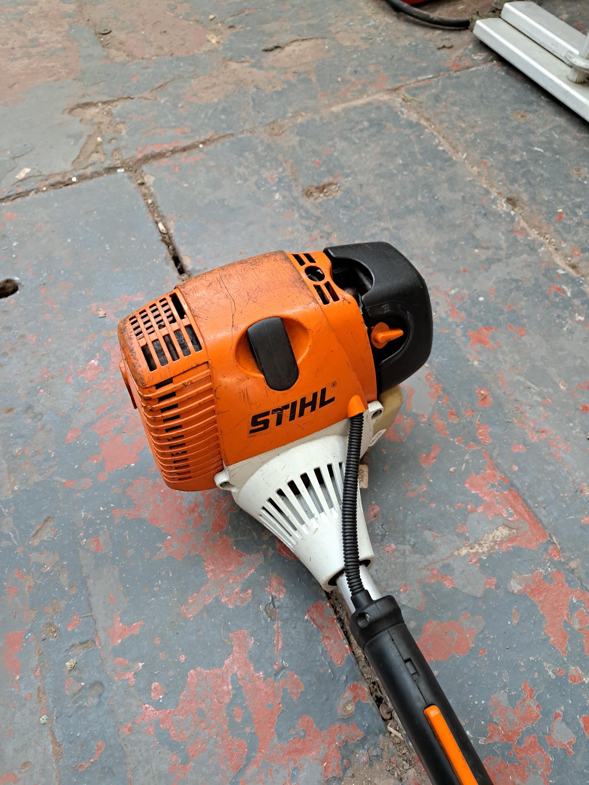 A Stihl KM130R petrol long reach multi tool with hedge cutter attachment