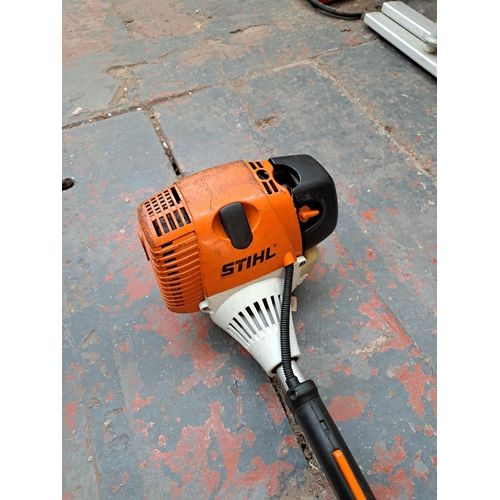 A Stihl KM130R petrol long reach multi tool with hedge cutter attachment