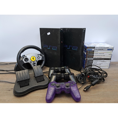 Two Sony PlayStation 2 consoles with controllers, Thrustmaster Racing ...