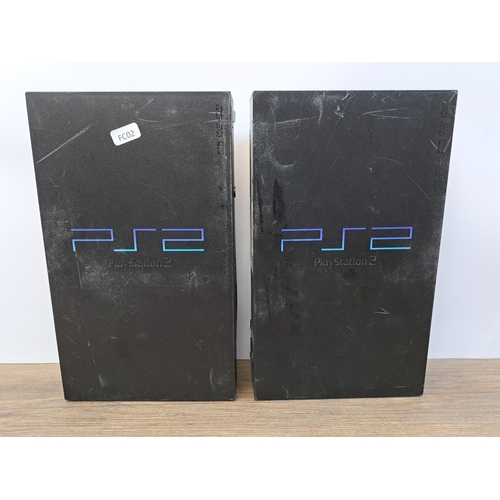 Two Sony PlayStation 2 consoles with controllers, Thrustmaster Racing ...