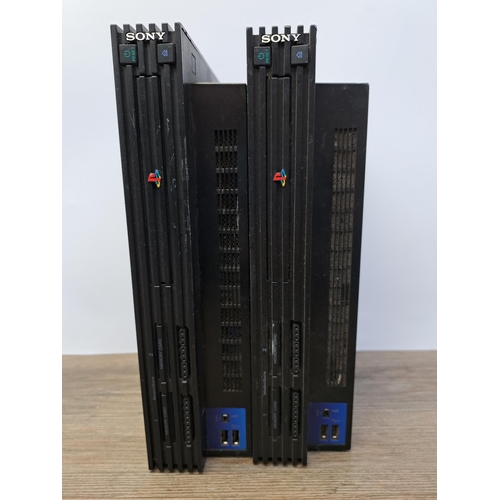 Two Sony PlayStation 2 consoles with controllers, Thrustmaster Racing ...