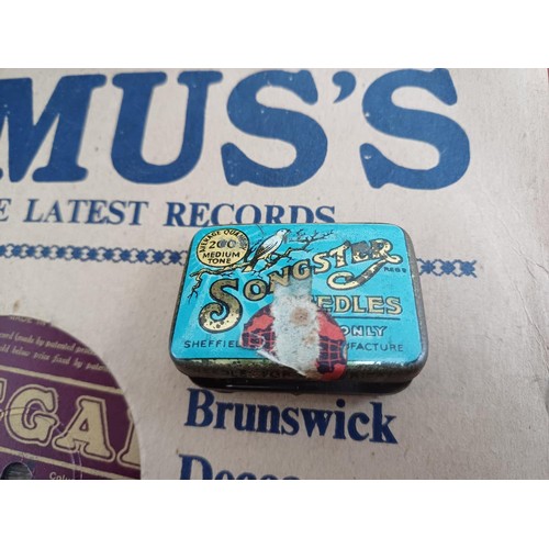 A vintage Selecta gramophone with winding handle, three shellac records ...