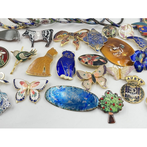 A collection of enamel jewellery to include brooches, bangles etc.