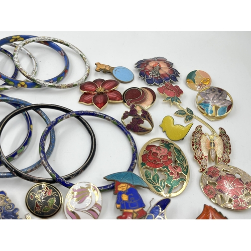 A collection of enamel jewellery to include brooches, bangles etc.