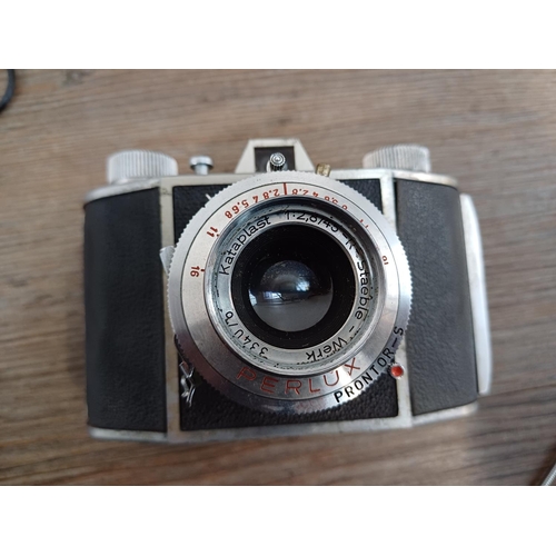 Two cased items, one Neidig Perlux 35mm camera fitted with Staeble ...
