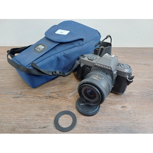 A cased Pentax P30T 35mm SLR camera fitted with Pentax-A 1:4-5.6 35 ...