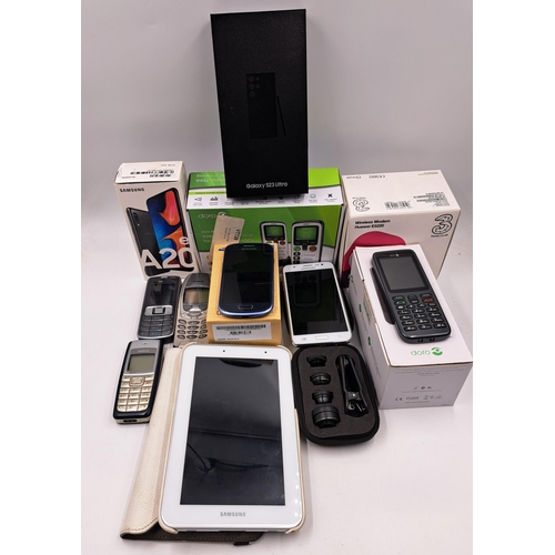 A collection of mobile phones, tablets, mobile phone boxes and ...