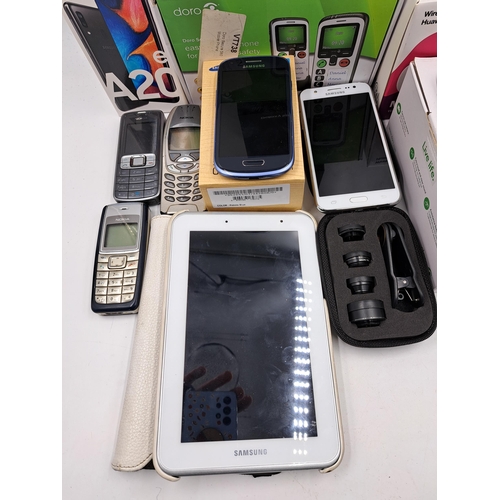 A collection of mobile phones, tablets, mobile phone boxes and ...