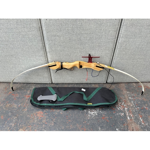A Selector International Corp archery bow with Opechee carry bag