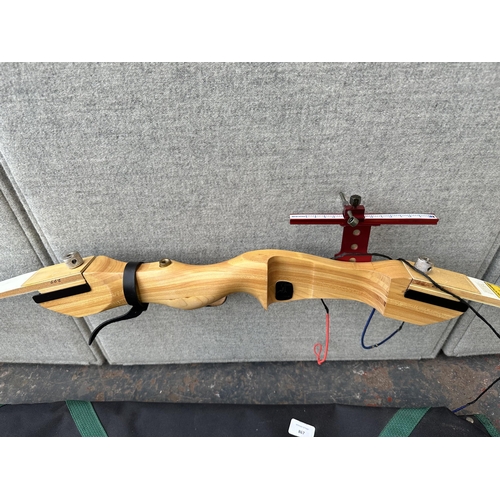 A Selector International Corp archery bow with Opechee carry bag