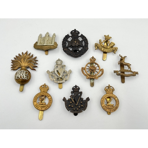 Ten military cap badges
