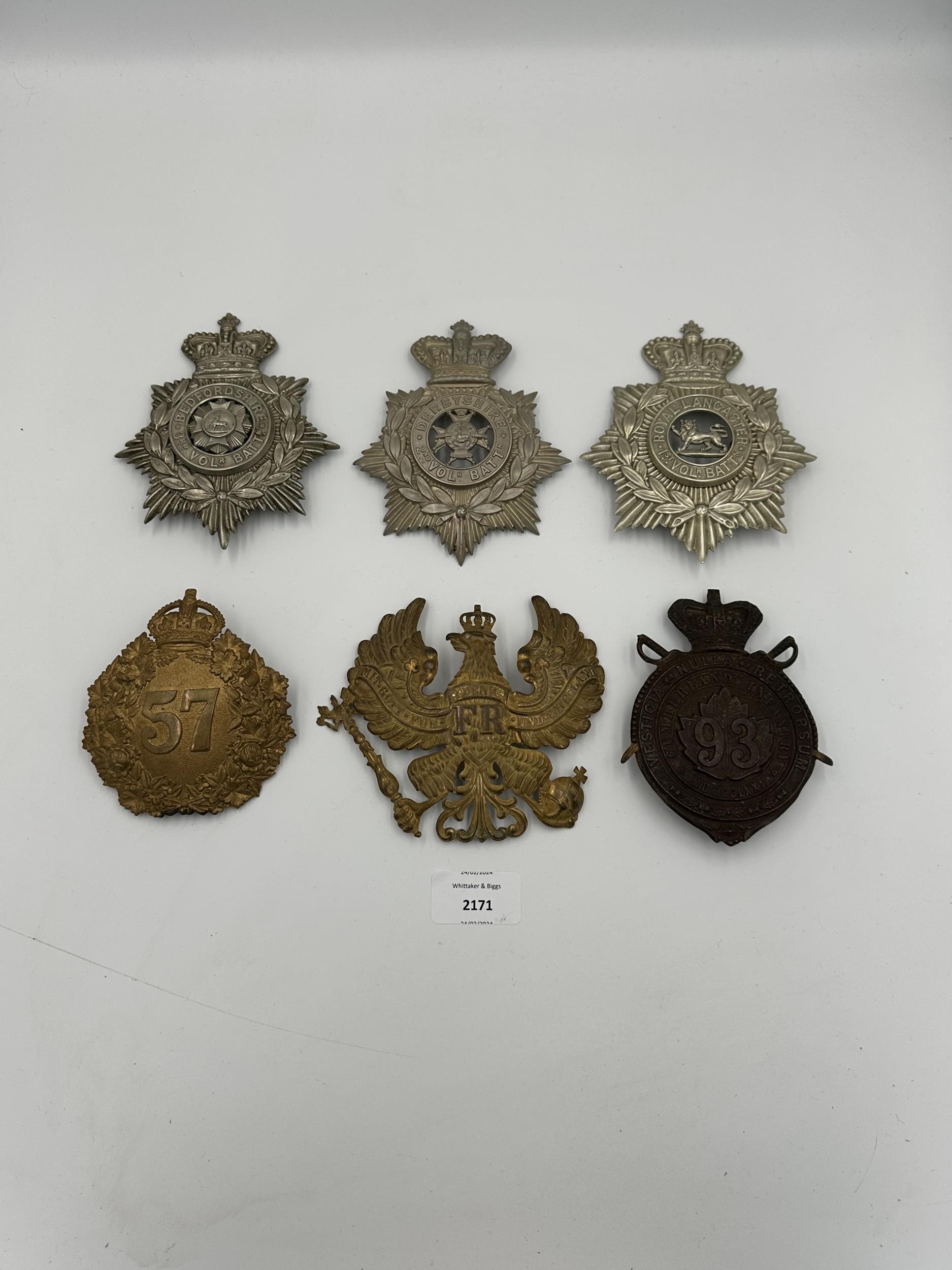 Six military helmet plates, four Victorian and two WWI