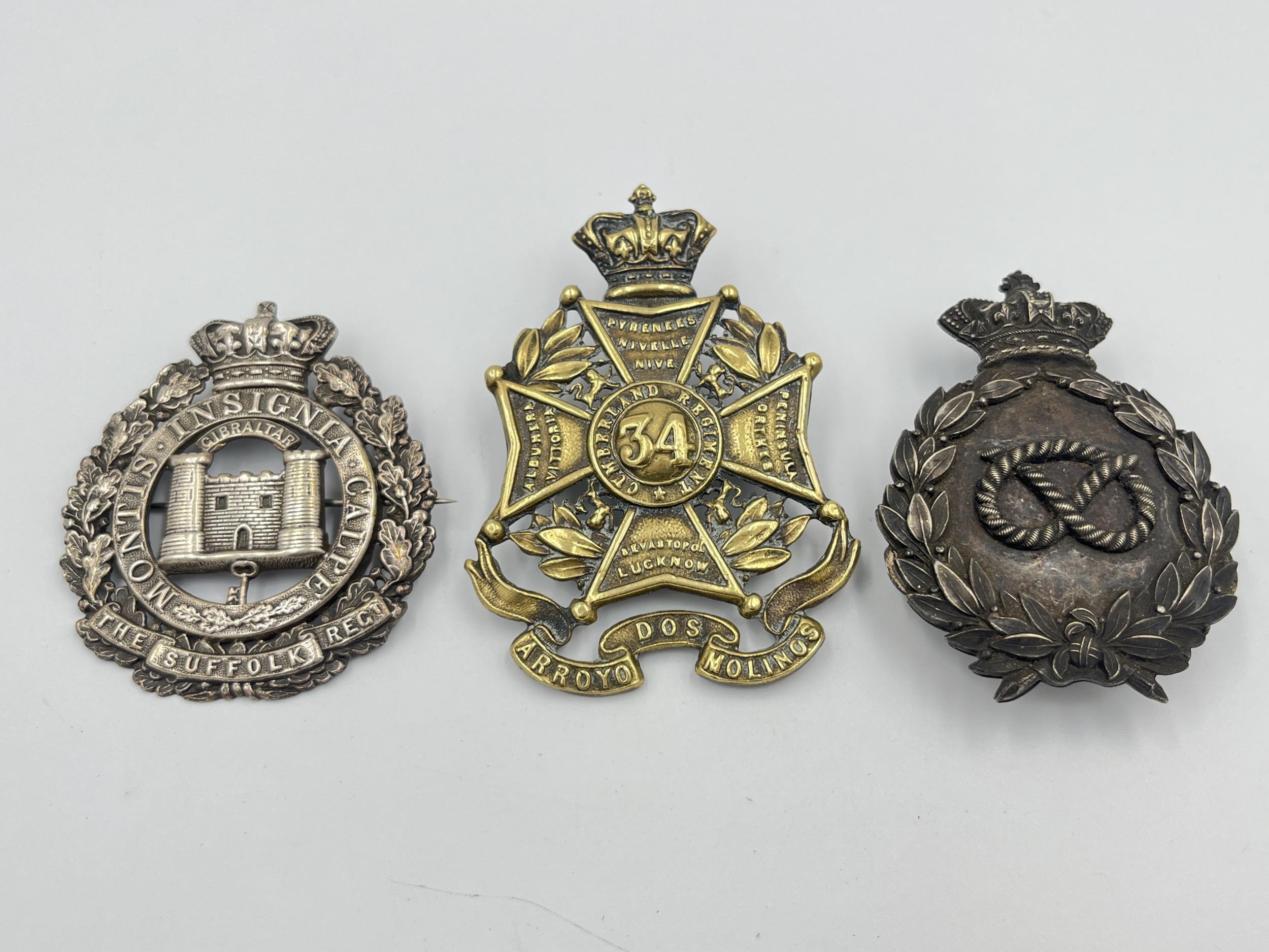 Three Victorian military cap badges to include 34th Foot Border ...