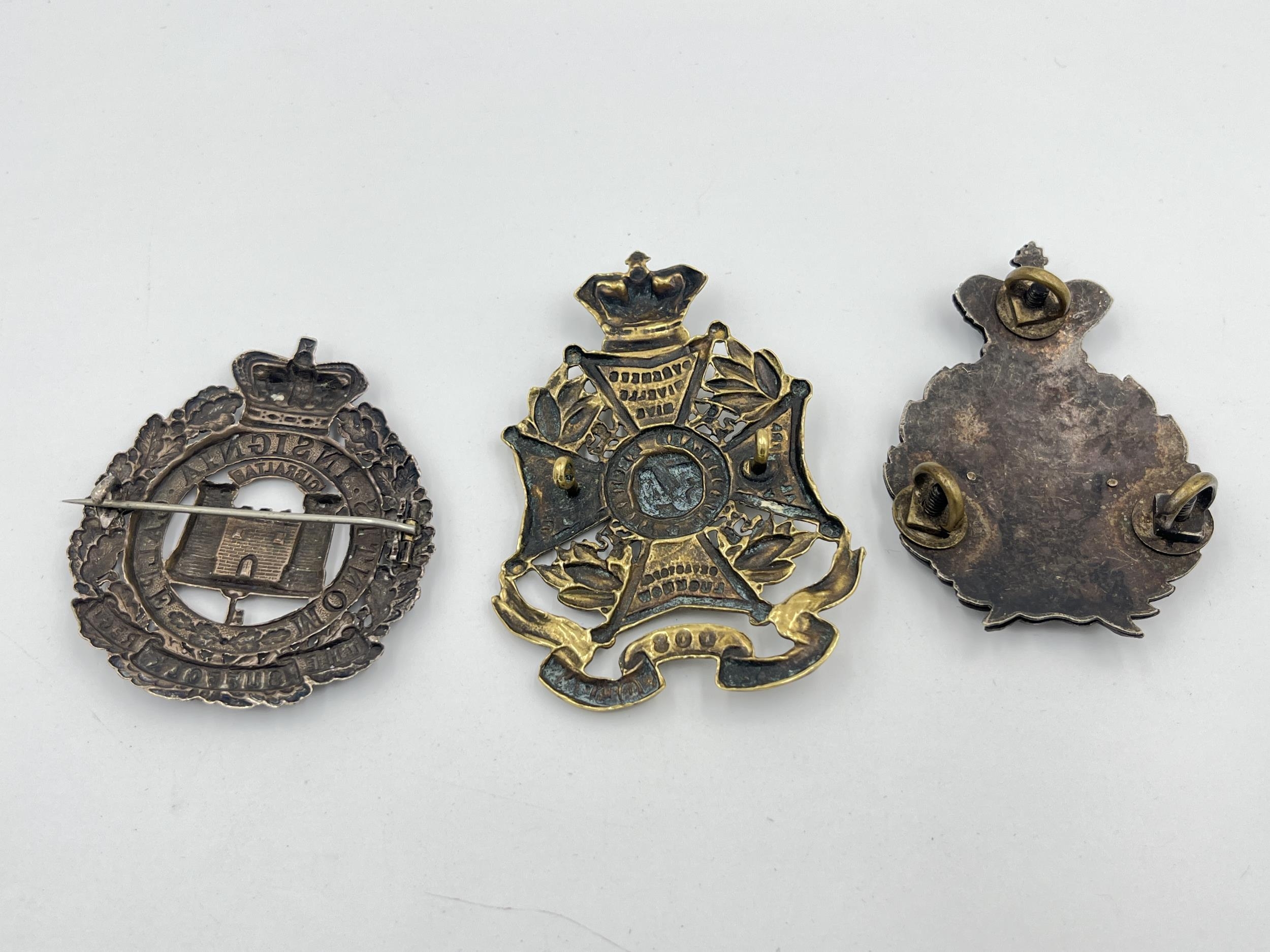 Three Victorian military cap badges to include 34th Foot Border ...