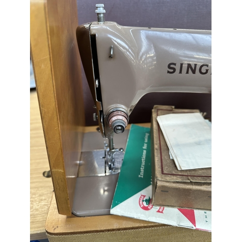 A cased Singer 185K electric sewing machine with boxed attachments and ...