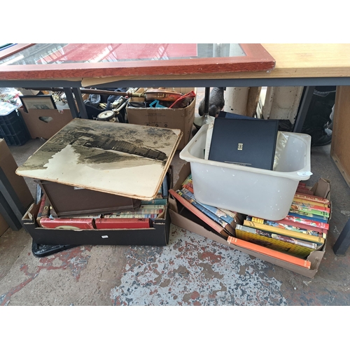 Two boxes containing a collection of vintage books and annuals to ...