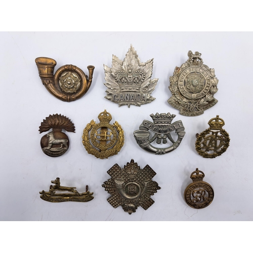 Ten military cap badges