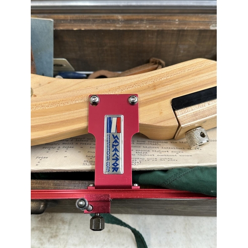 A Selector archery bow with arrows and accessories