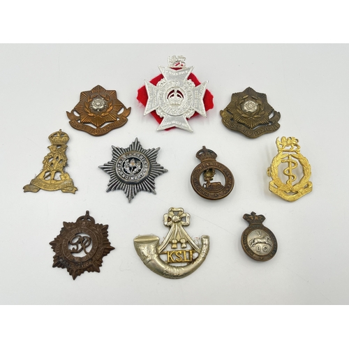 Ten military cap badges