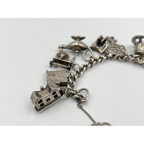 A .925 sterling silver charm bracelet with assorted white metal and ...