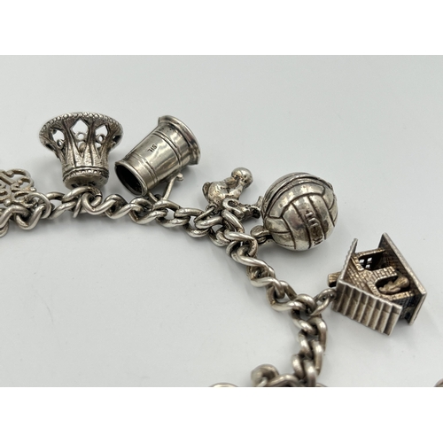 A .925 sterling silver charm bracelet with assorted white metal and ...