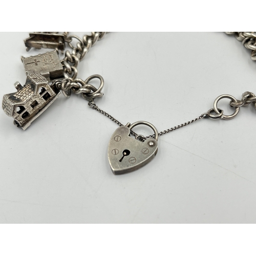 A .925 sterling silver charm bracelet with assorted white metal and ...