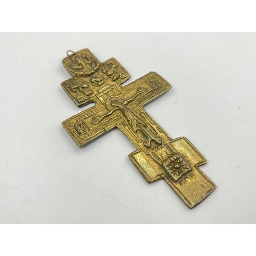 An antique Russian Orthodox brass wall cross - approx. 11cm high x 6cm wide